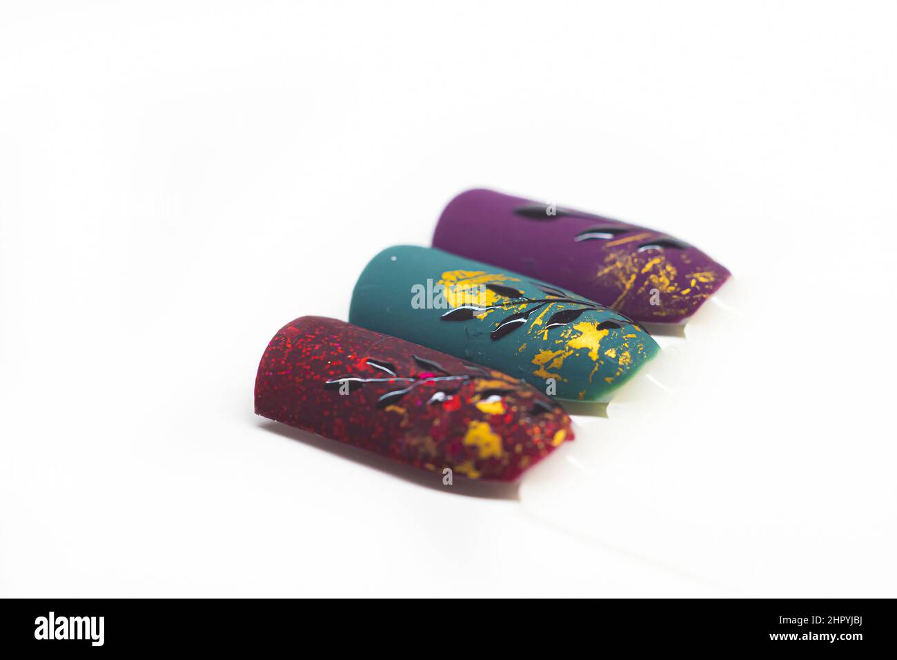Colorful plastic matte nail designs on a white background Stock Photo ...