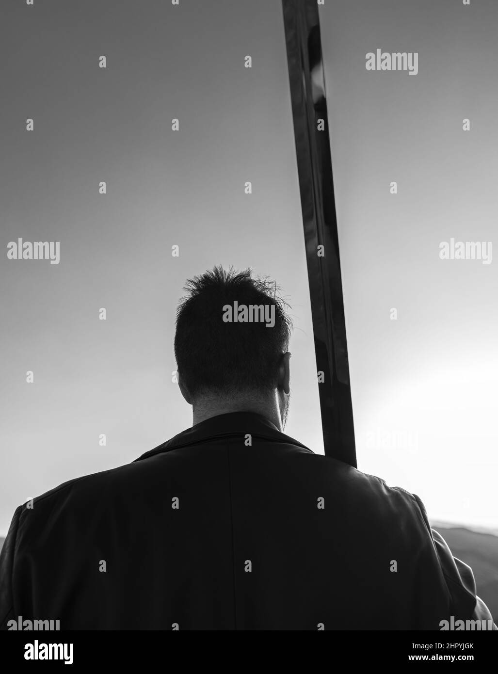Man wearing a leather coat and holding a sword Stock Photo - Alamy