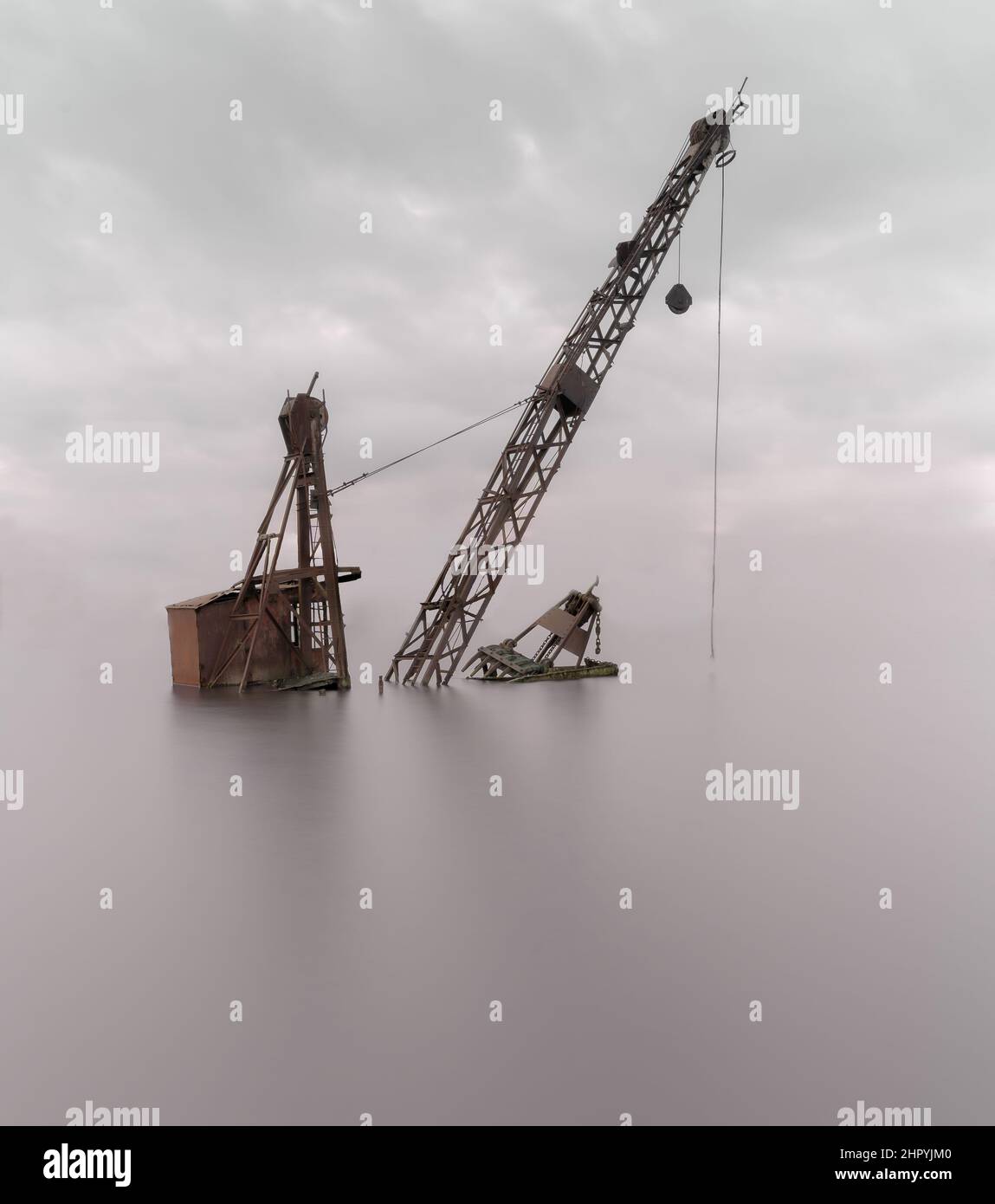 Abandoned crane in a sea under the cloudy skies Stock Photo - Alamy