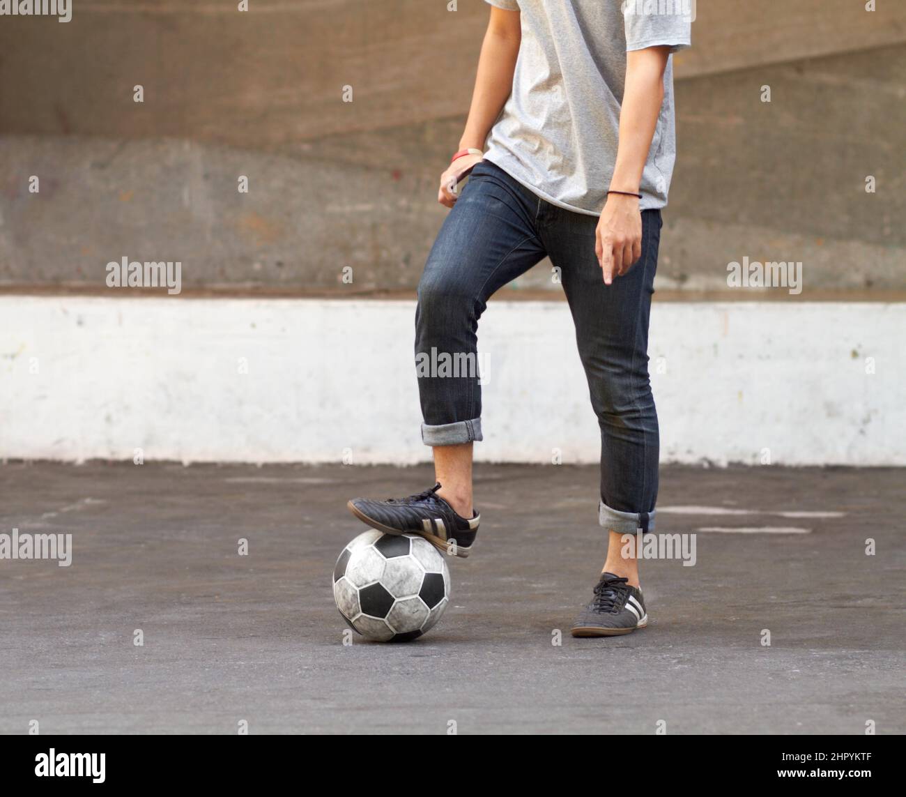 Taking control of the game. Shot of a young people playing football in ...