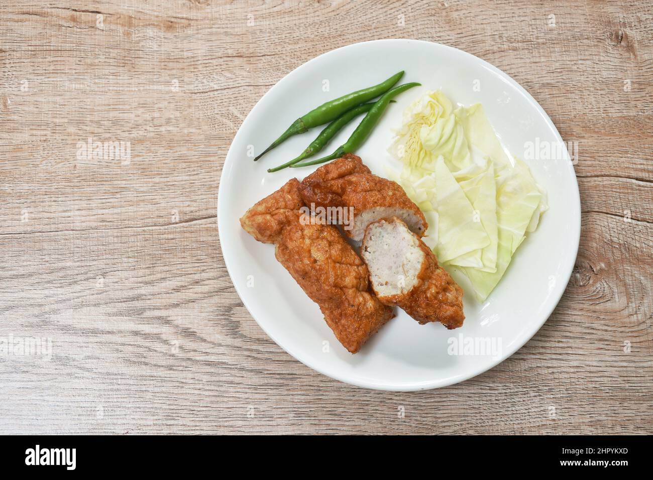 fried fermenting fish line eat with fresh cabbage and chili on plate ...