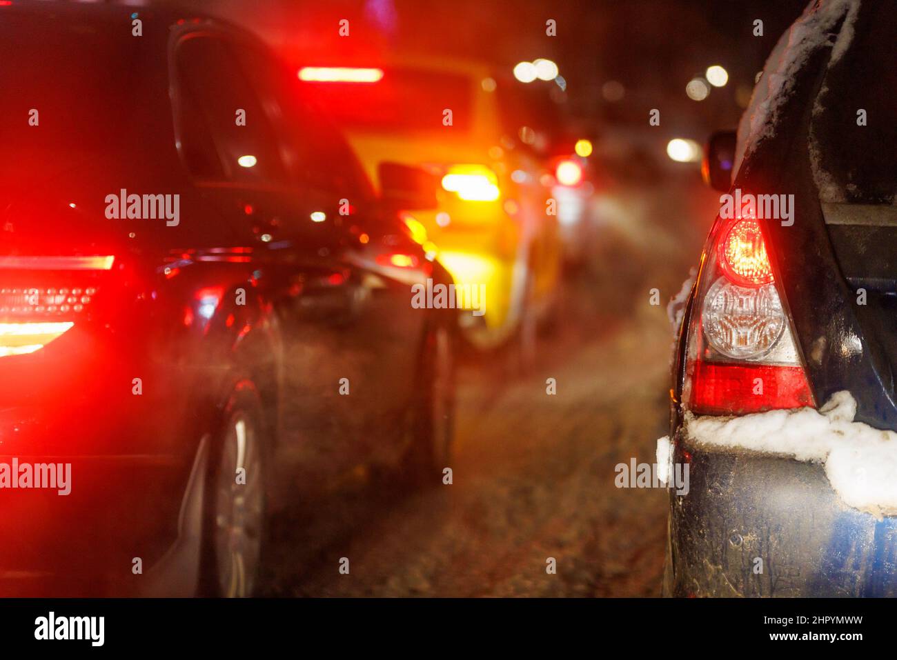 close-up view of car tail light and right turn signal at winter night ...