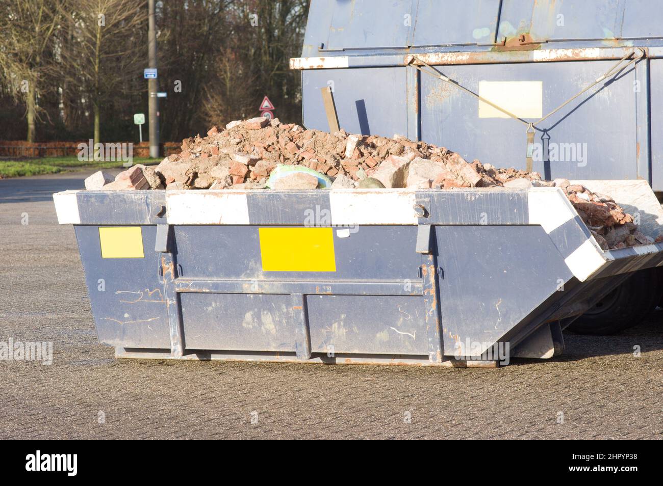 Closeup of a blue dumpster with construction waste in the Netherlands ...