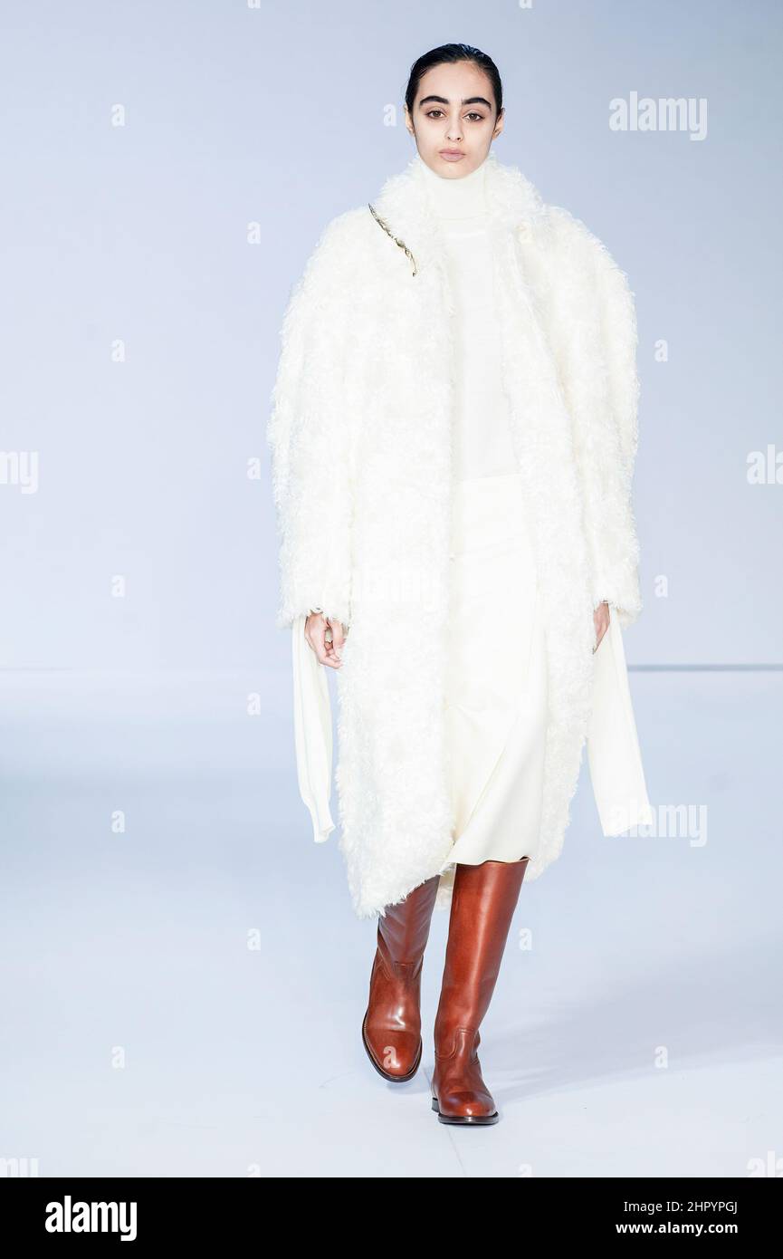 Milan, Italy. 23rd Feb, 2022. A model wearing a white coat walks the ...