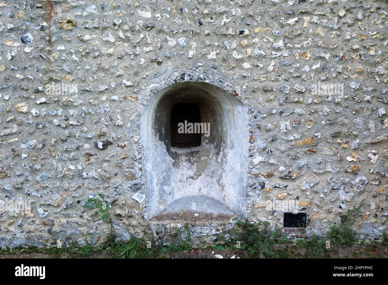 Hagioscope in the exterior wall of St Mary's church, The Street, Brook ...