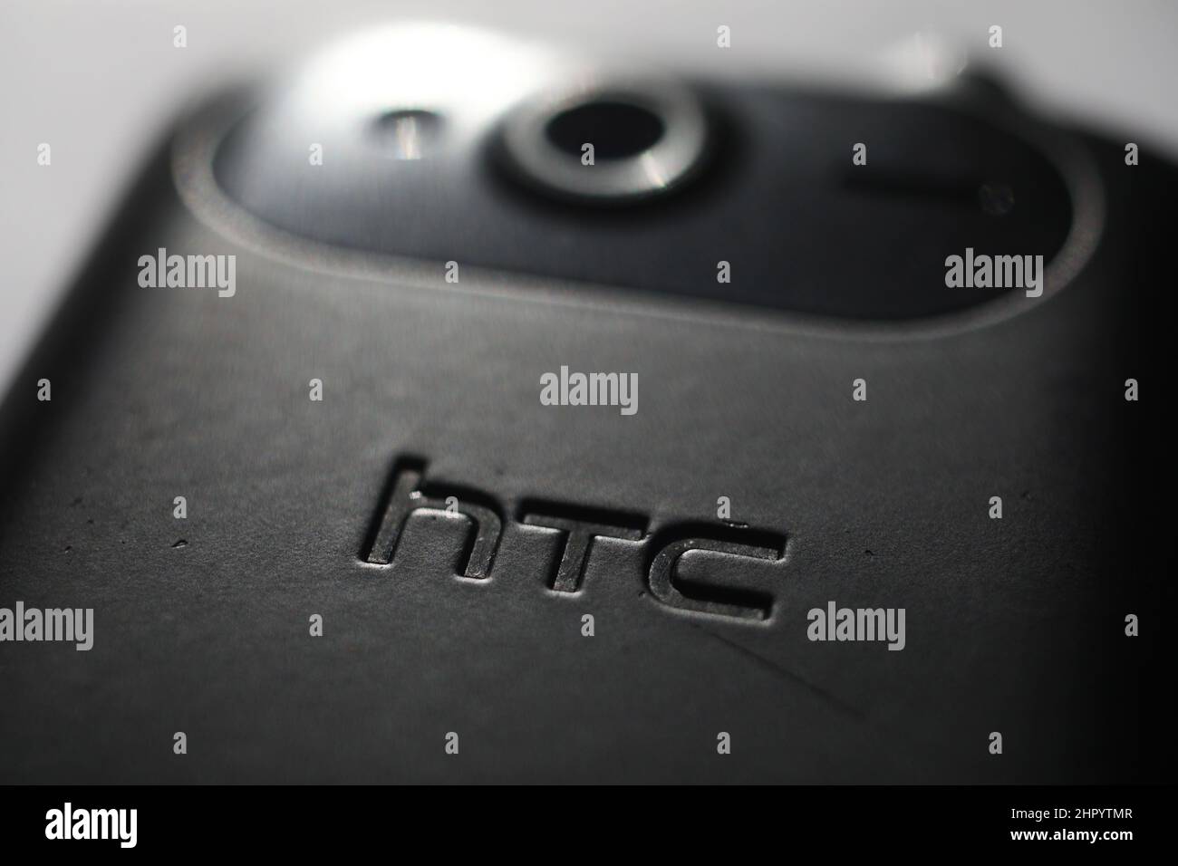 Old mobile phones on a kitchen table in a home. In the picture: A HTC ...