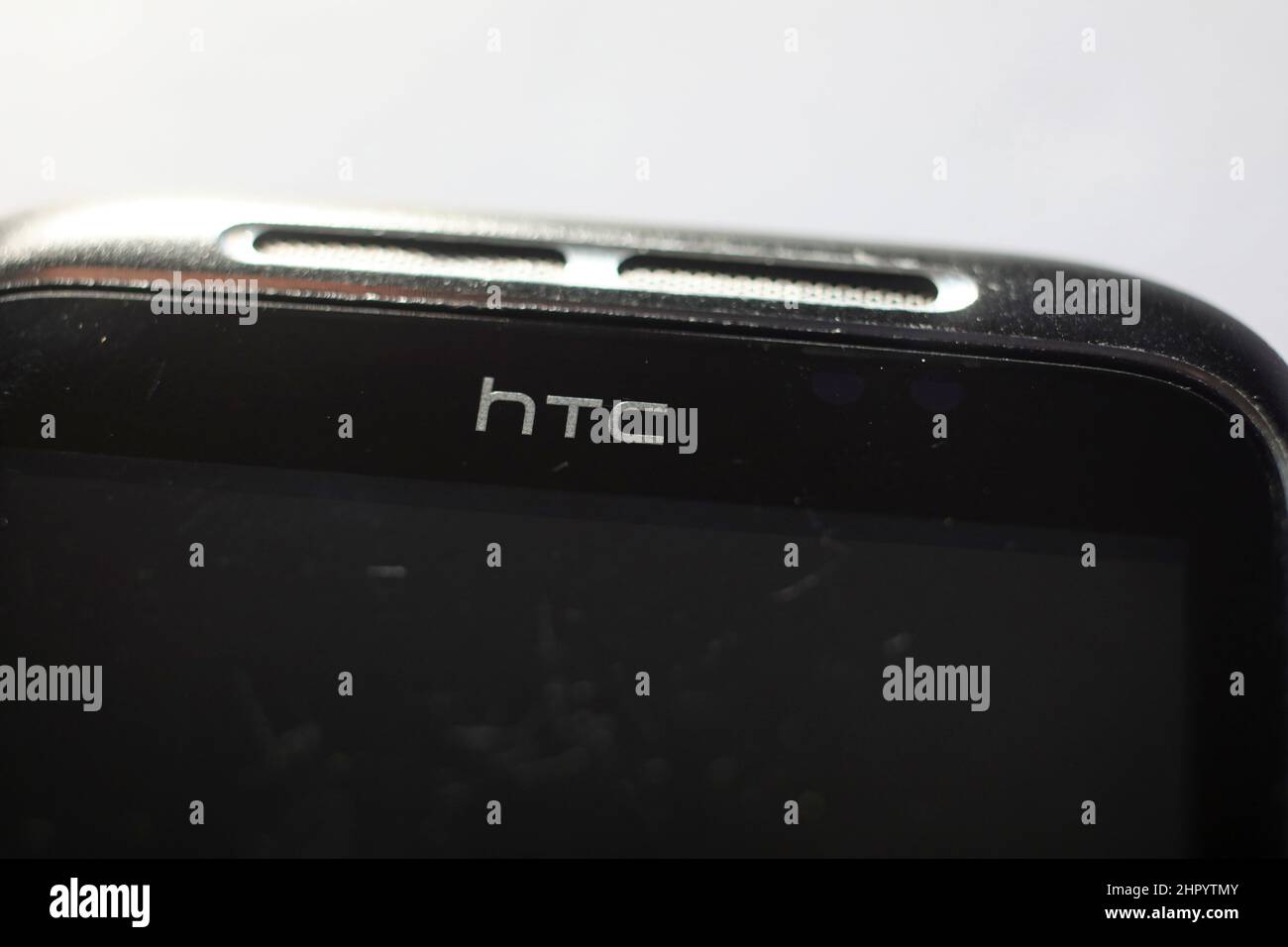 Old mobile phones on a kitchen table in a home. In the picture: A HTC ...