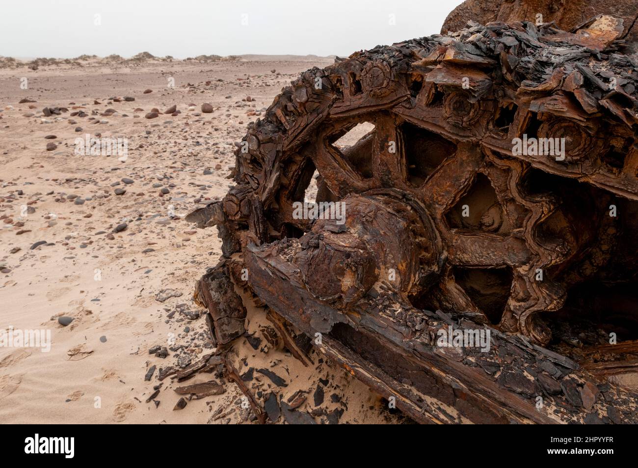 A rusted derelict Caterpillar used in diamond mining, buried in sand ...