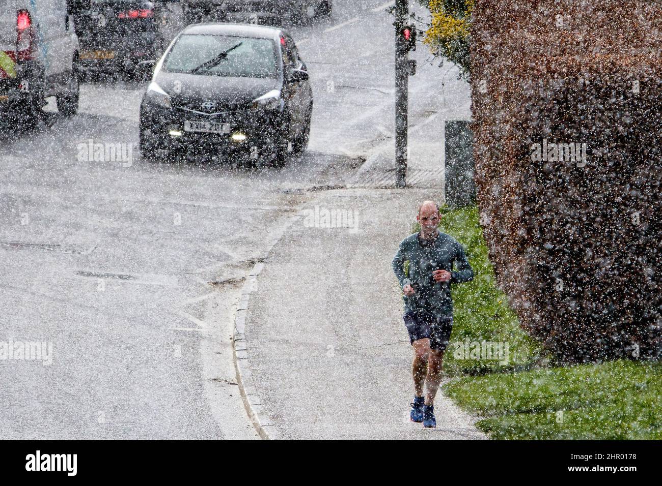 Chippenham, Wiltshire, UK. 24th February, 2022. A man out running is ...