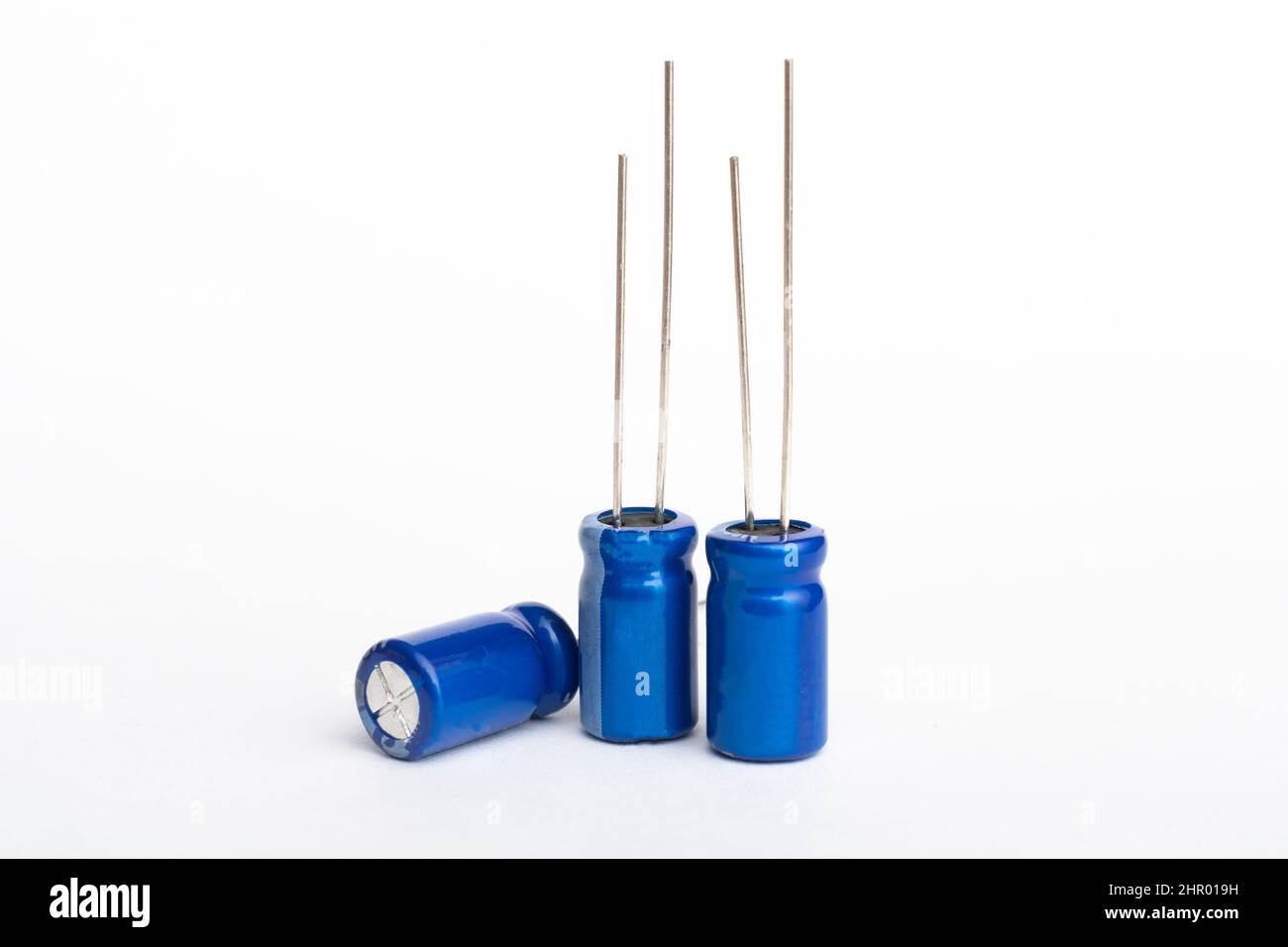 Three blue electrolytic capacitors isolated on white background Stock ...
