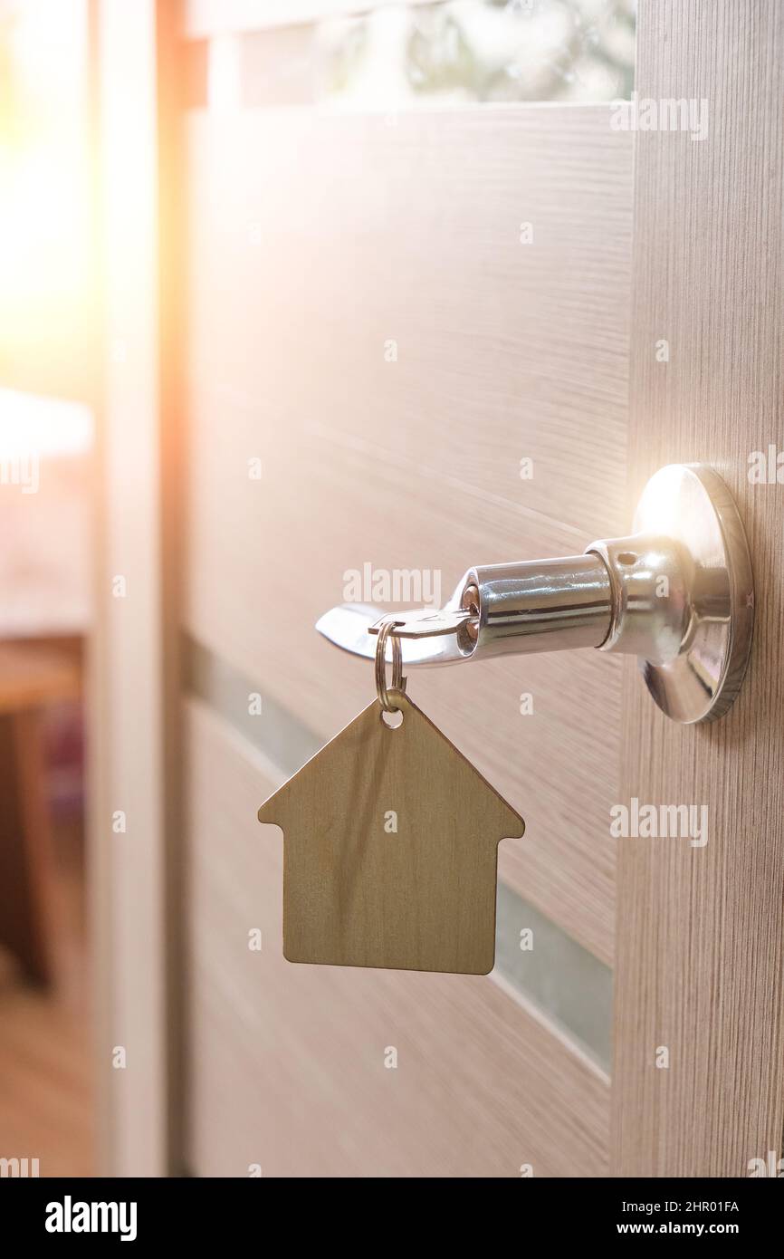 Key with keychain in form house in door lock.With bright sunlight Stock ...