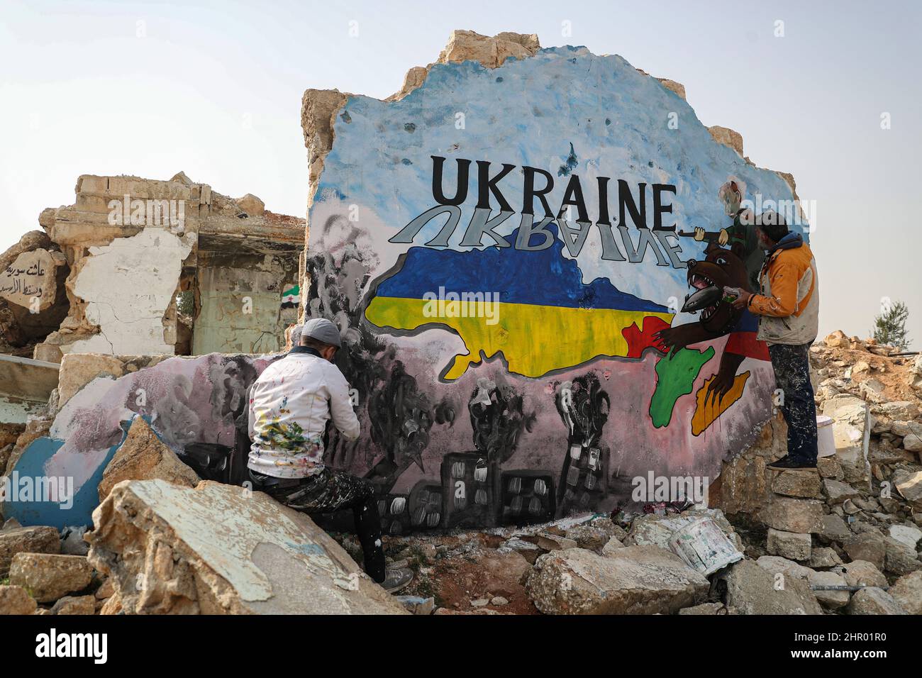Binnish, Syria. 24th Feb, 2022. Syrian painters draw a mural in ...