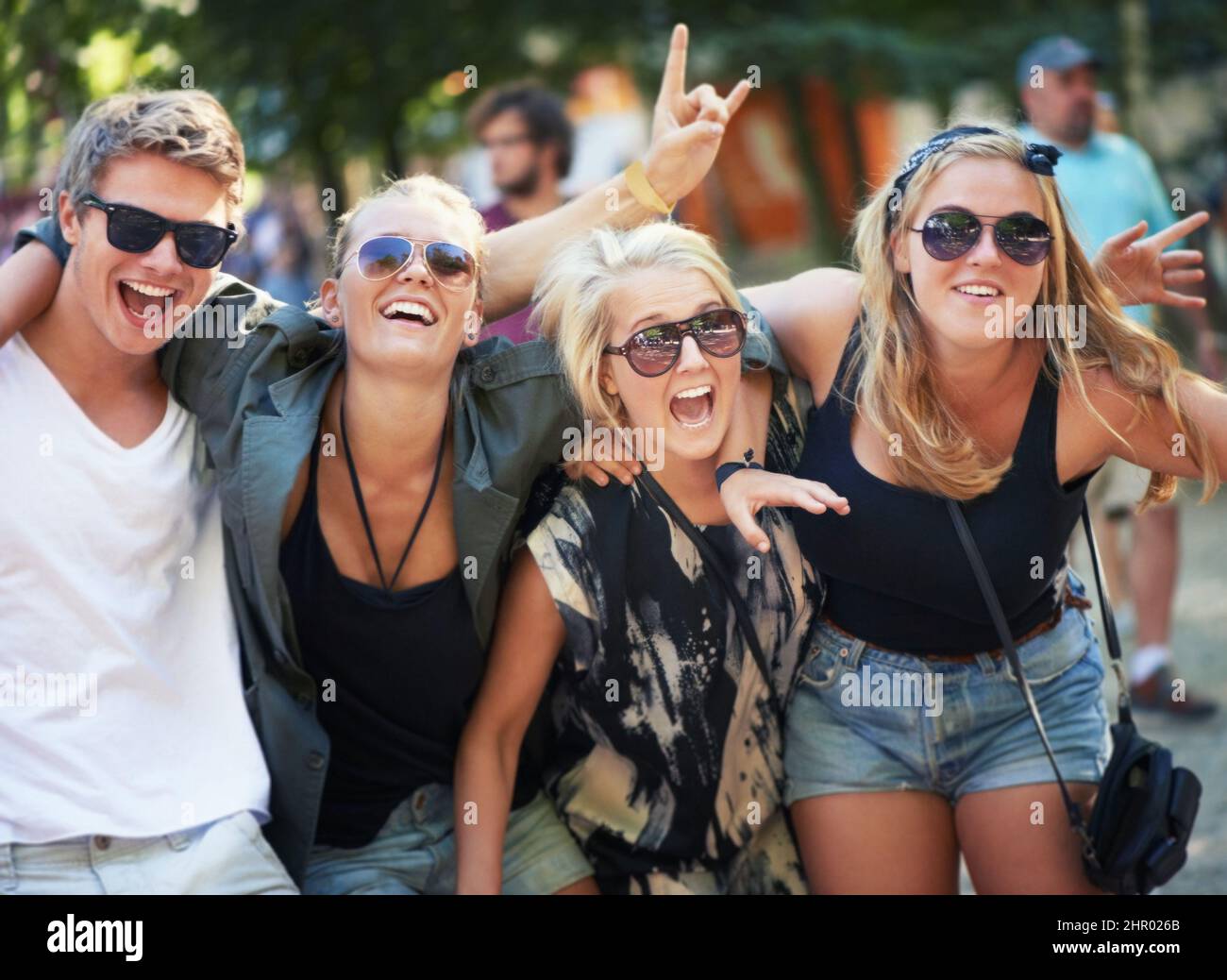 High on music and life. Four young friends rocking out to a band at a ...