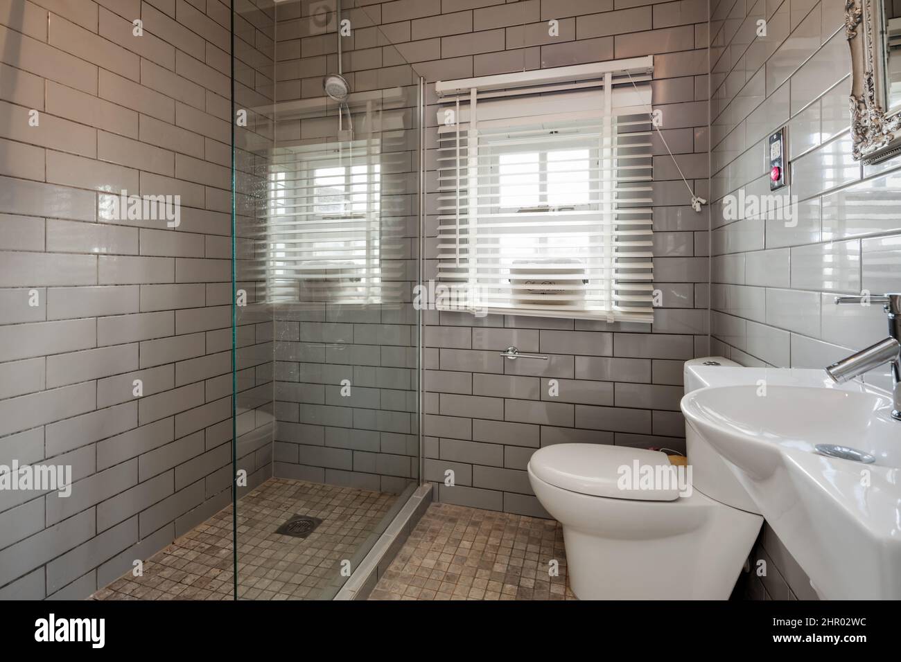 Luxury modern walk in shower with glass panel and fully tiled walls ...
