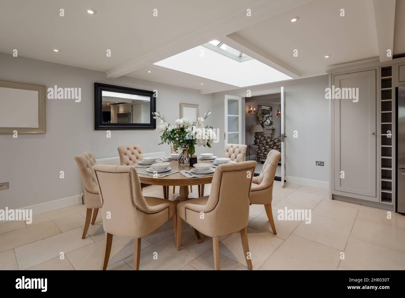 Dining table with place settings inclusing bowls and plates and flower ...