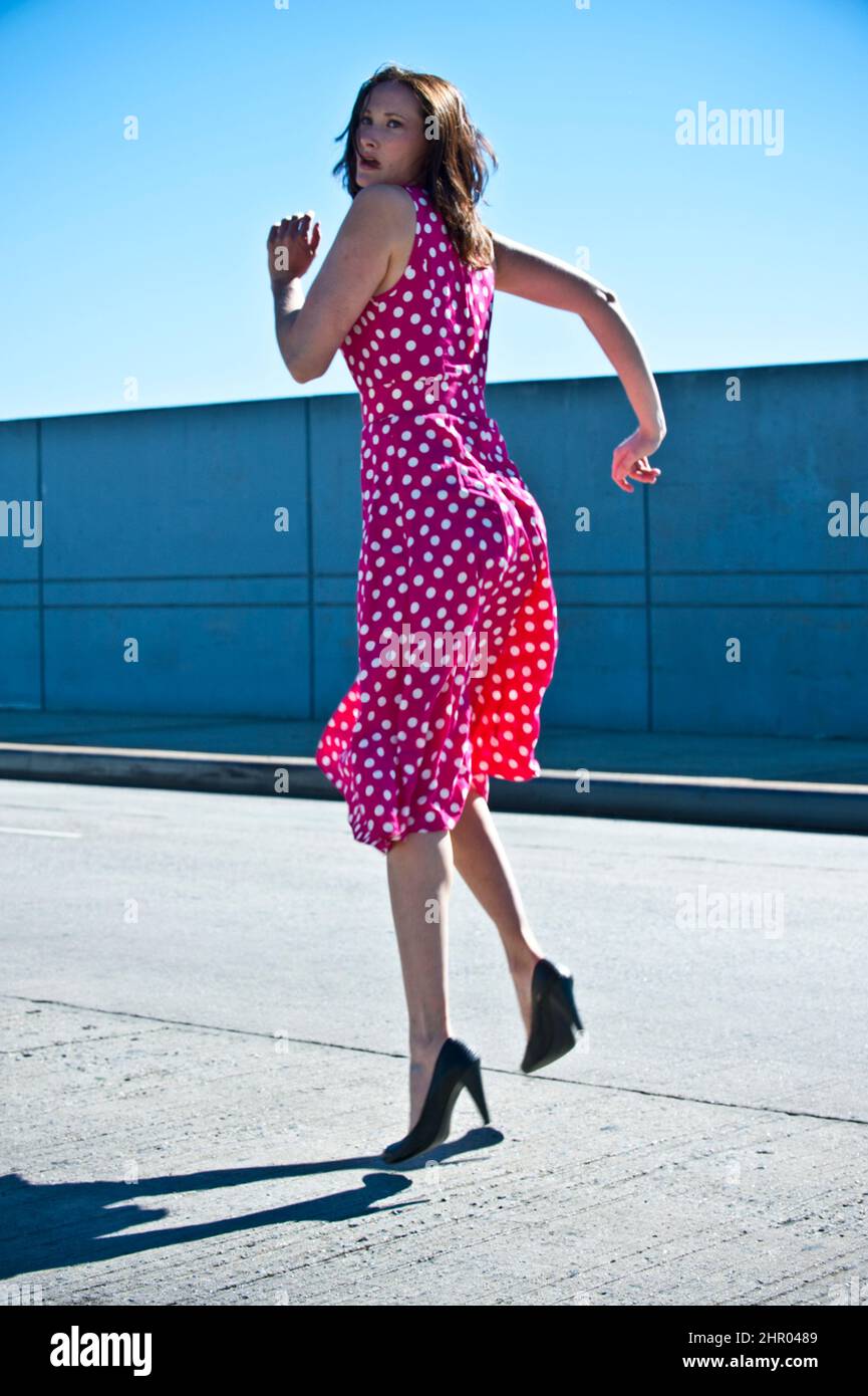 Woman looking over shoulder fear hi-res stock photography and images ...