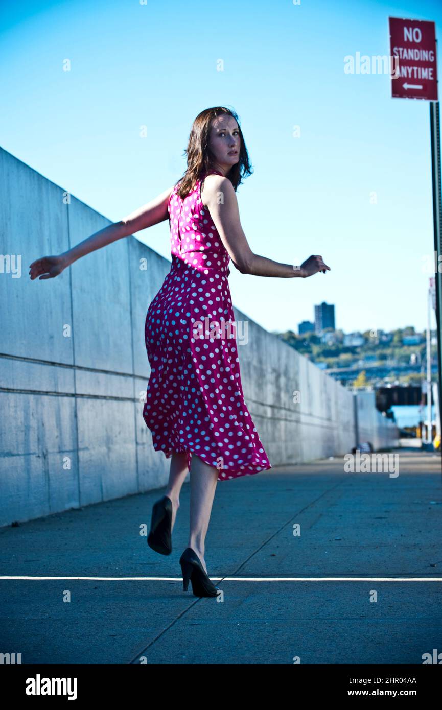 Woman running down sidewalk, rear view Stock Photo - Alamy