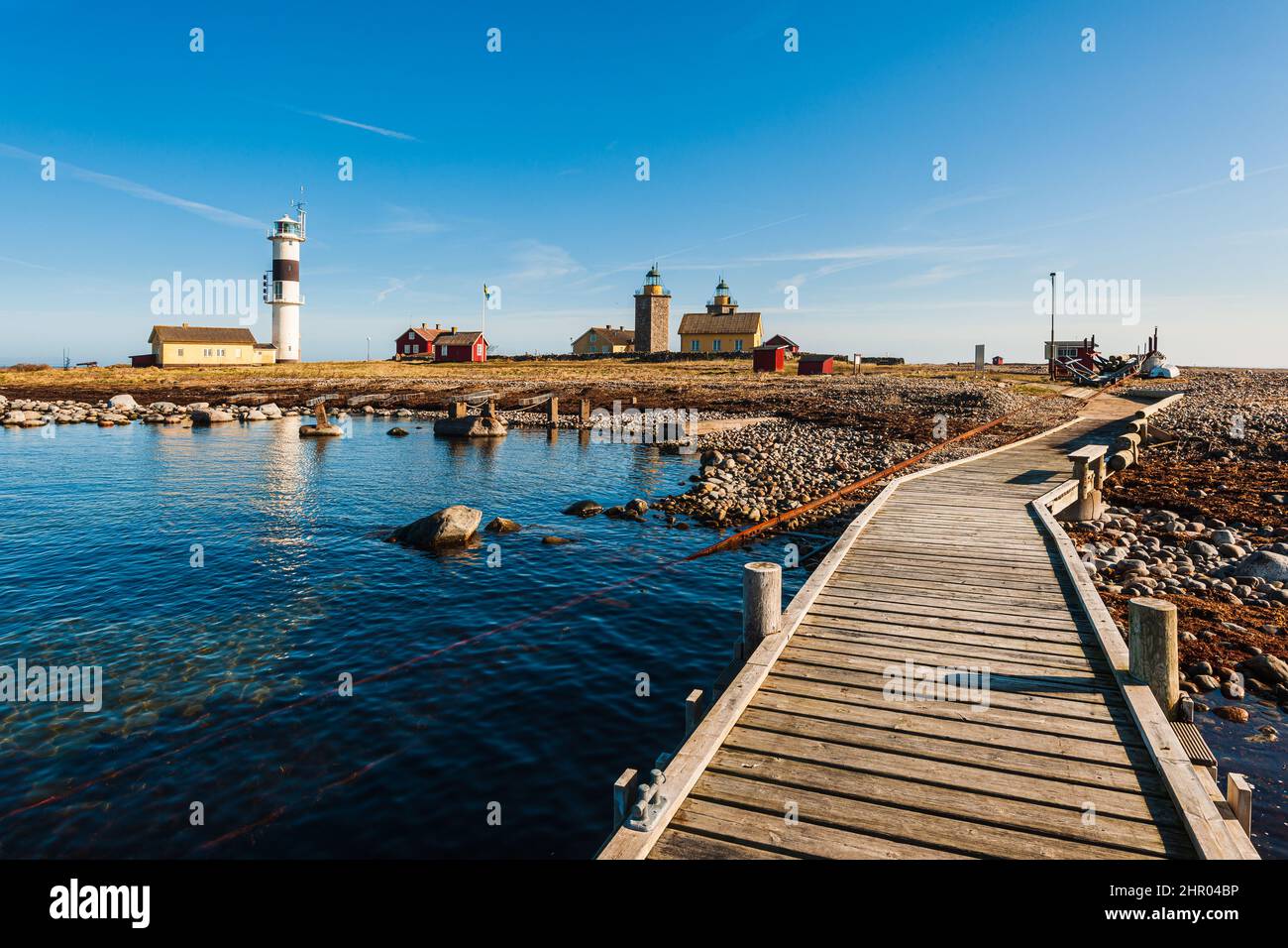 Wooden jetty in front of lighthouse station Stock Photo - Alamy