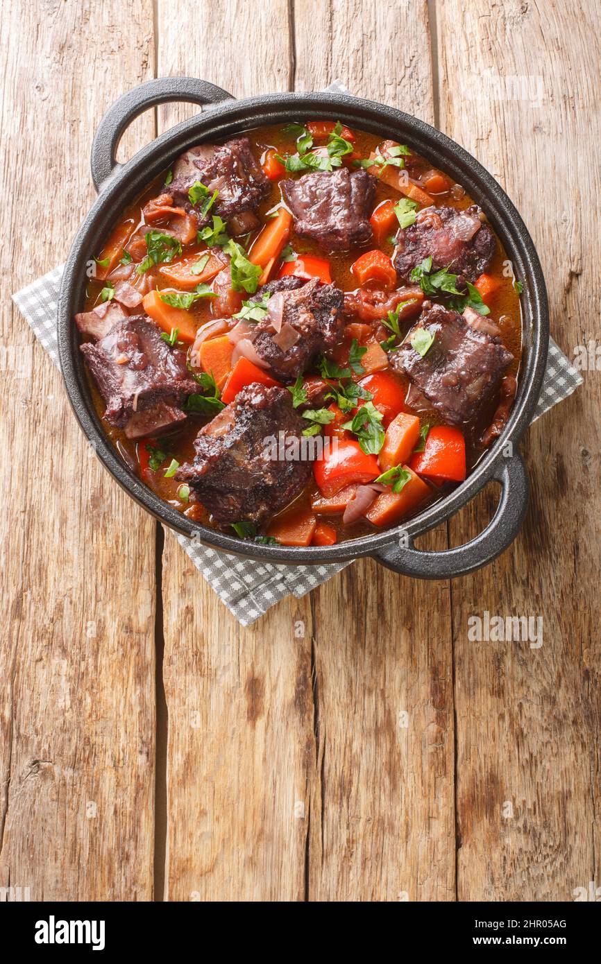 Spanish Bull Tail Stew Rabo De Toro closeup on a pot on the wooden ...