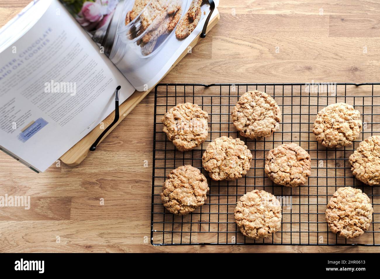 A batch of freshly baked cookies cooling on a cooling rack sitting on a ...
