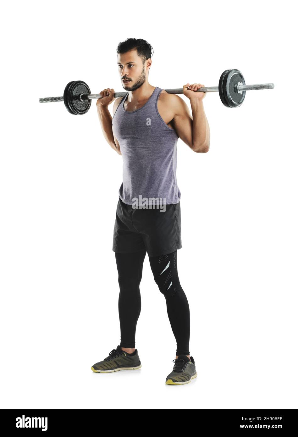 Studio shot a young man working out with a barbell against a white ...