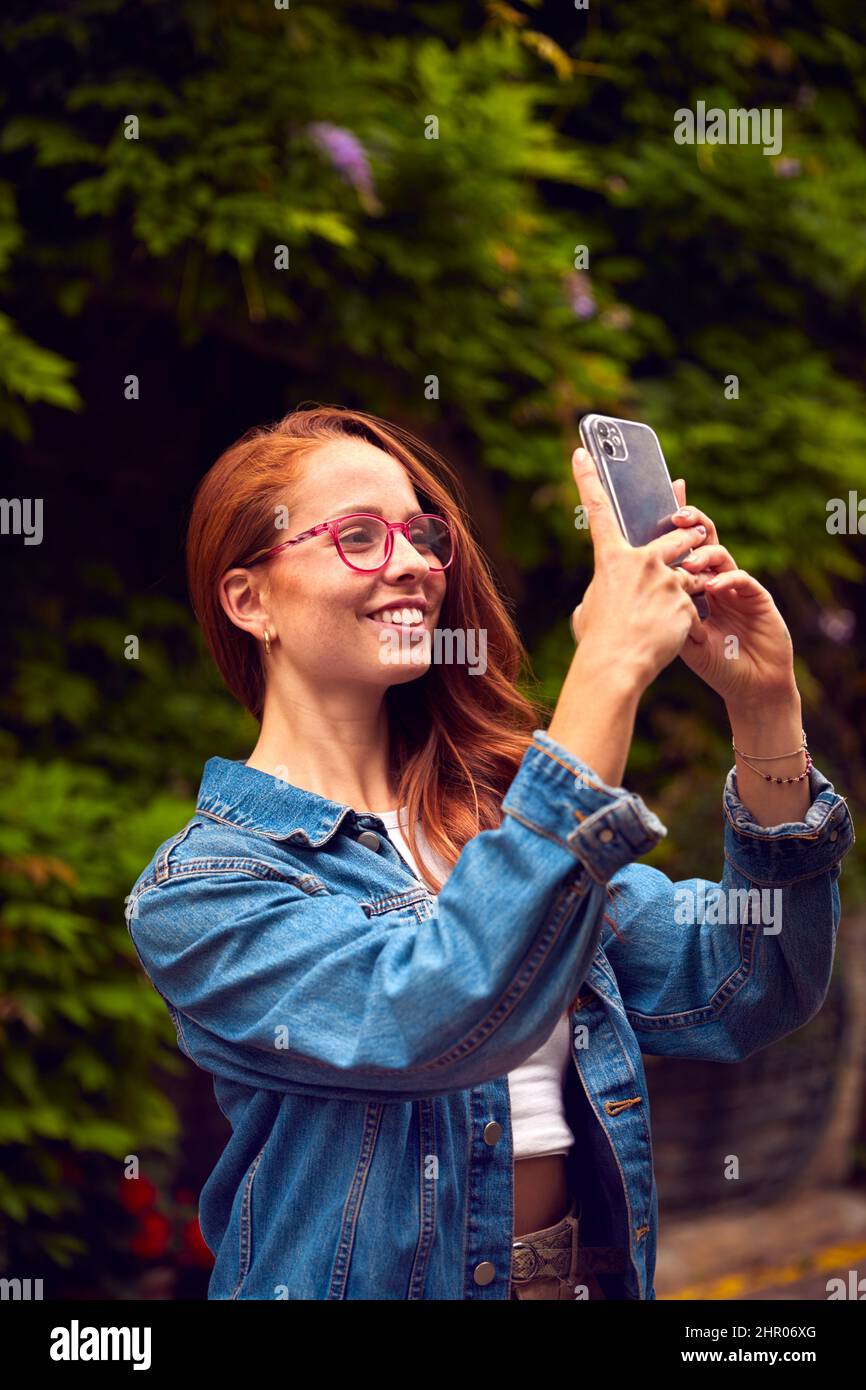 Female Vlogger Or Social Influencer In City Taking Selfie On Mobile ...