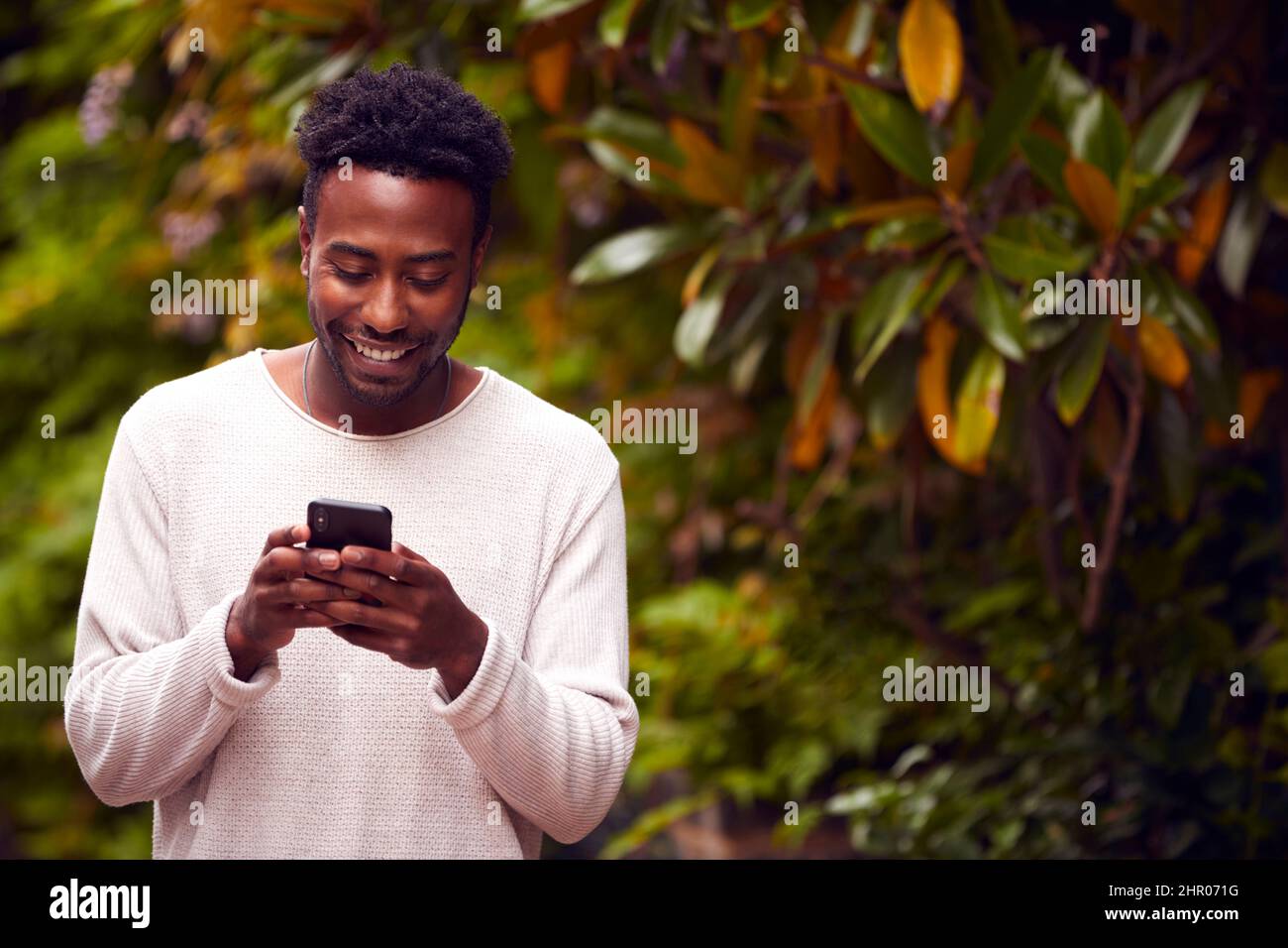 Male Vlogger Or Social Influencer In City Using Mobile Phone On Street ...