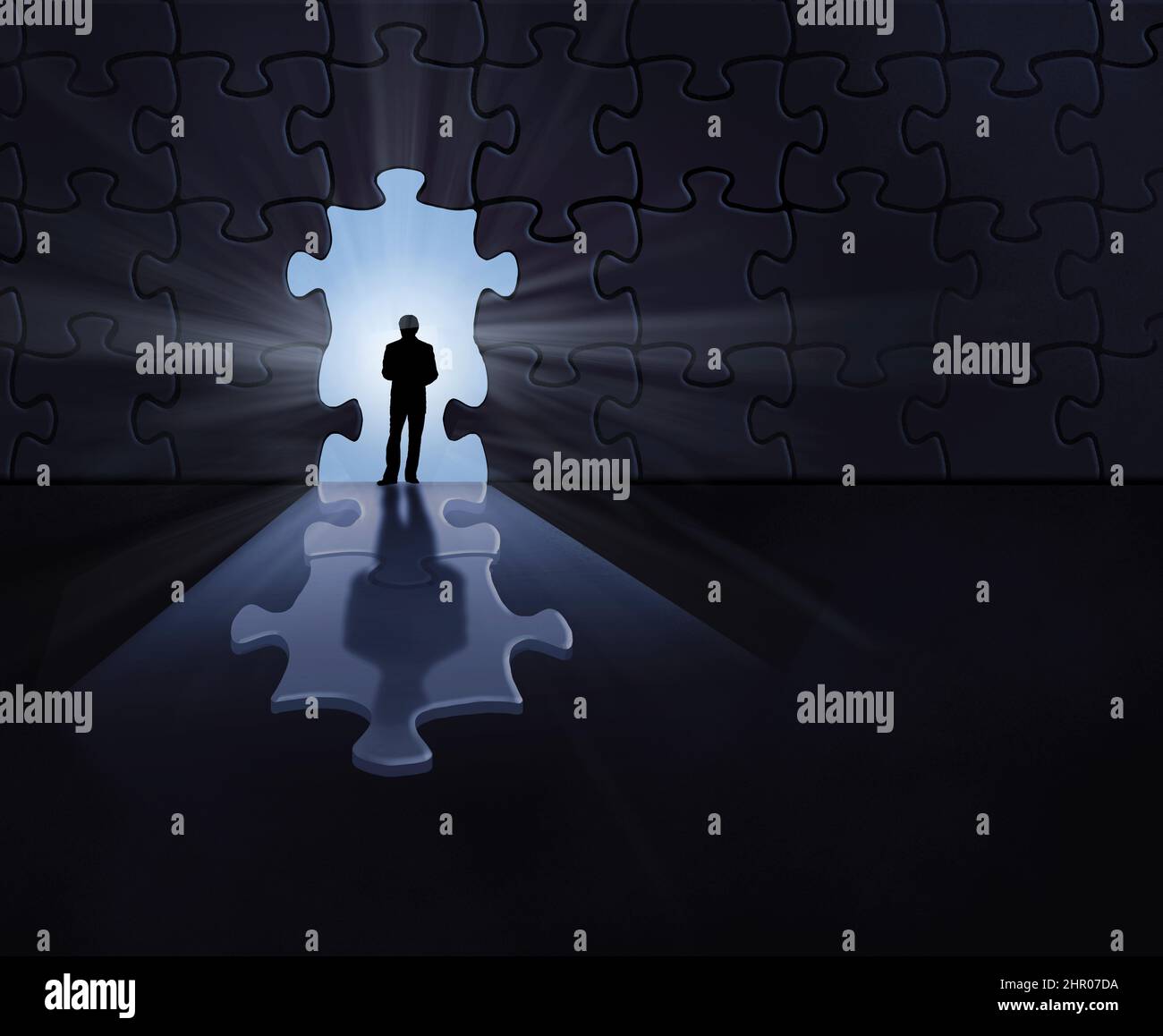 . A wall of jigsaw puzzle pieces has an opening after the break through ...