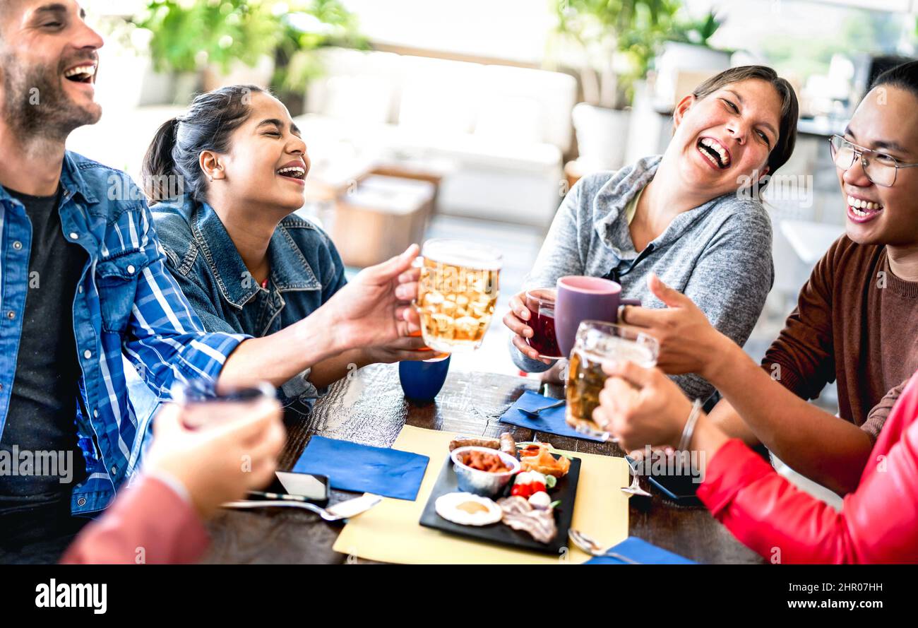 Young gen z people toasting beer at coffee bar brunch - Students ...
