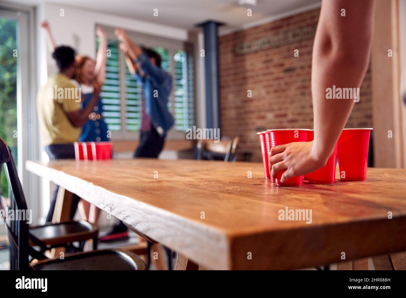 Multi-Cultural Group Of Friends Playing Game At Home Together Throwing ...