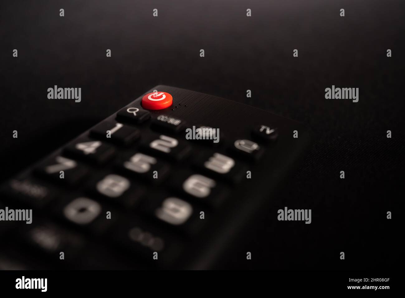 TV power button on the remote control on black background Stock Photo ...
