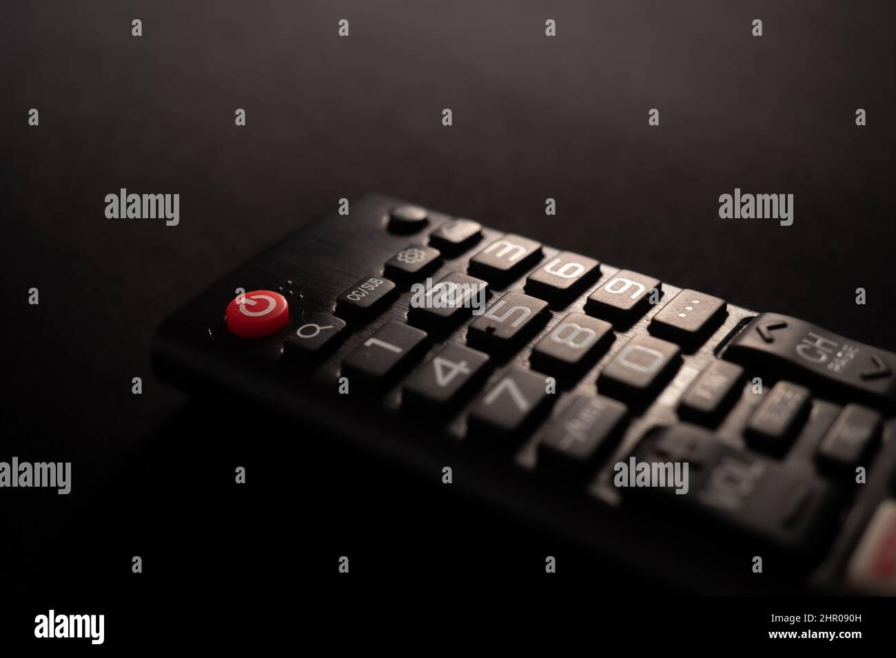 TV power button on the remote control on black background Stock Photo ...