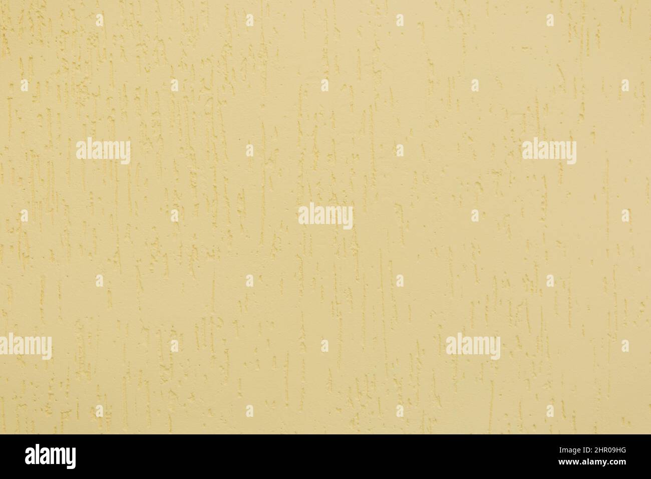 Light soft yellow paint color on plastered wall surface with abstract ...