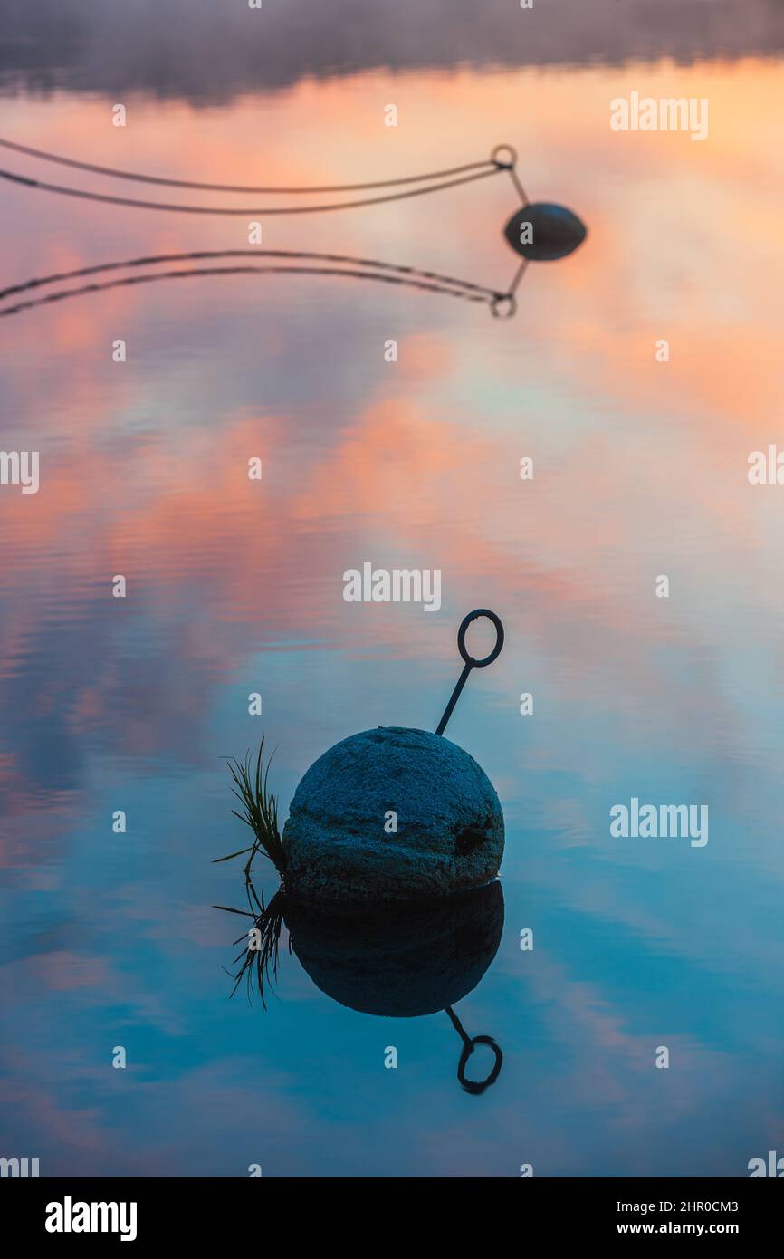 Bouy lying in colorful lake Stock Photo - Alamy