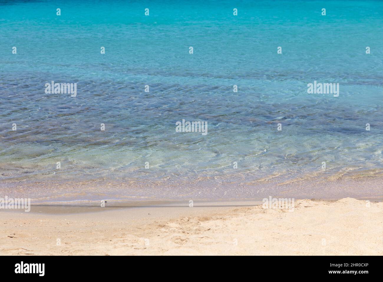 Sandy empty beach, turquoise ocean sea water touch wet sand. Greece ...