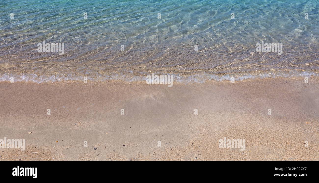Sandy beach, ocean sea water touch wet sand close up. Greece summer ...