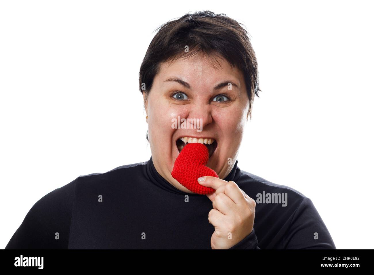 brunette woman wants to bite red heart isolated on white background ...