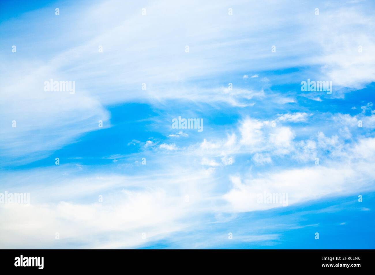 Huge clouds in blue sky lit by the sun, windy day Stock Photo - Alamy