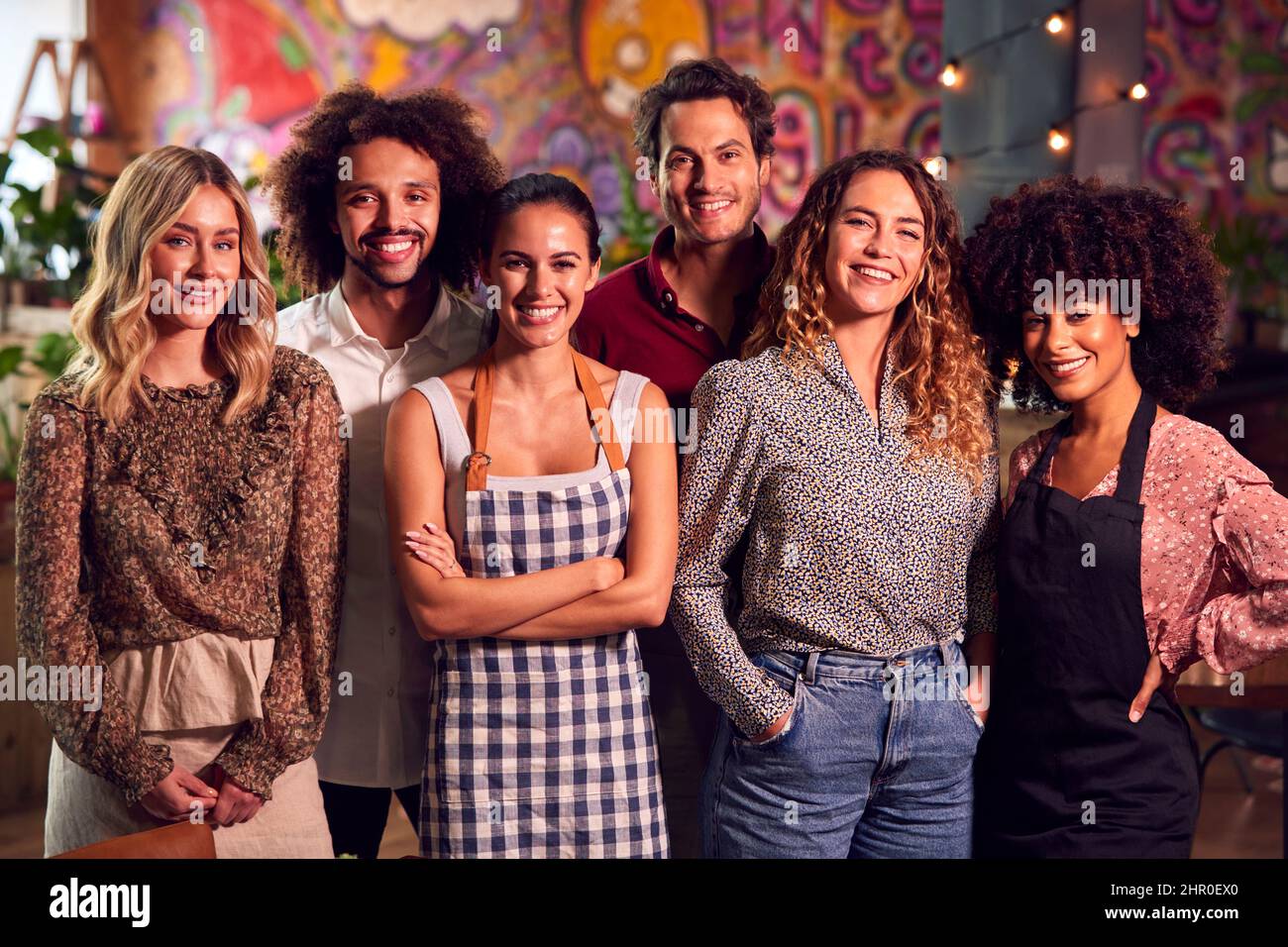 Portrait Of Smiling Multi-Cultural Team Of Servers Bar Staff And Owner ...