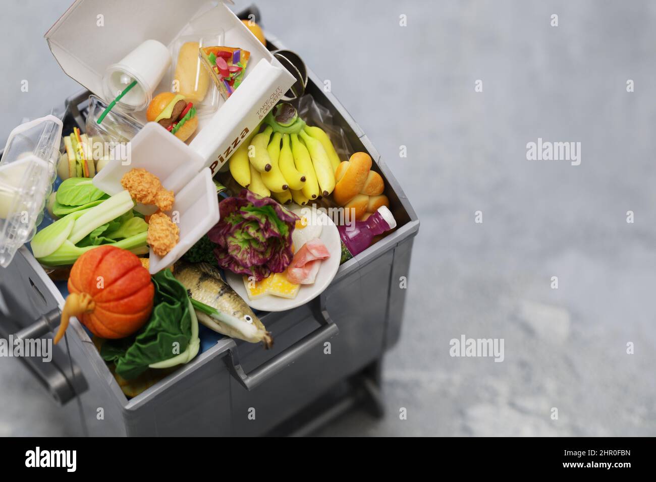 Garbage trash can, Image of food waste made in miniature. The letters ...