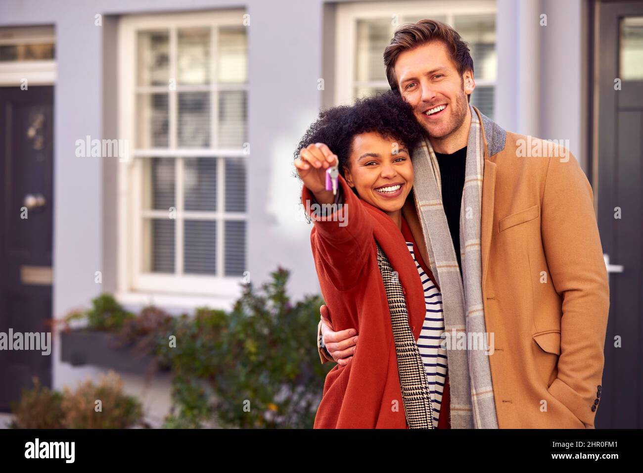 Portrait Of Multi Cultural Couple Outdoors On Moving Day Holding Keys ...