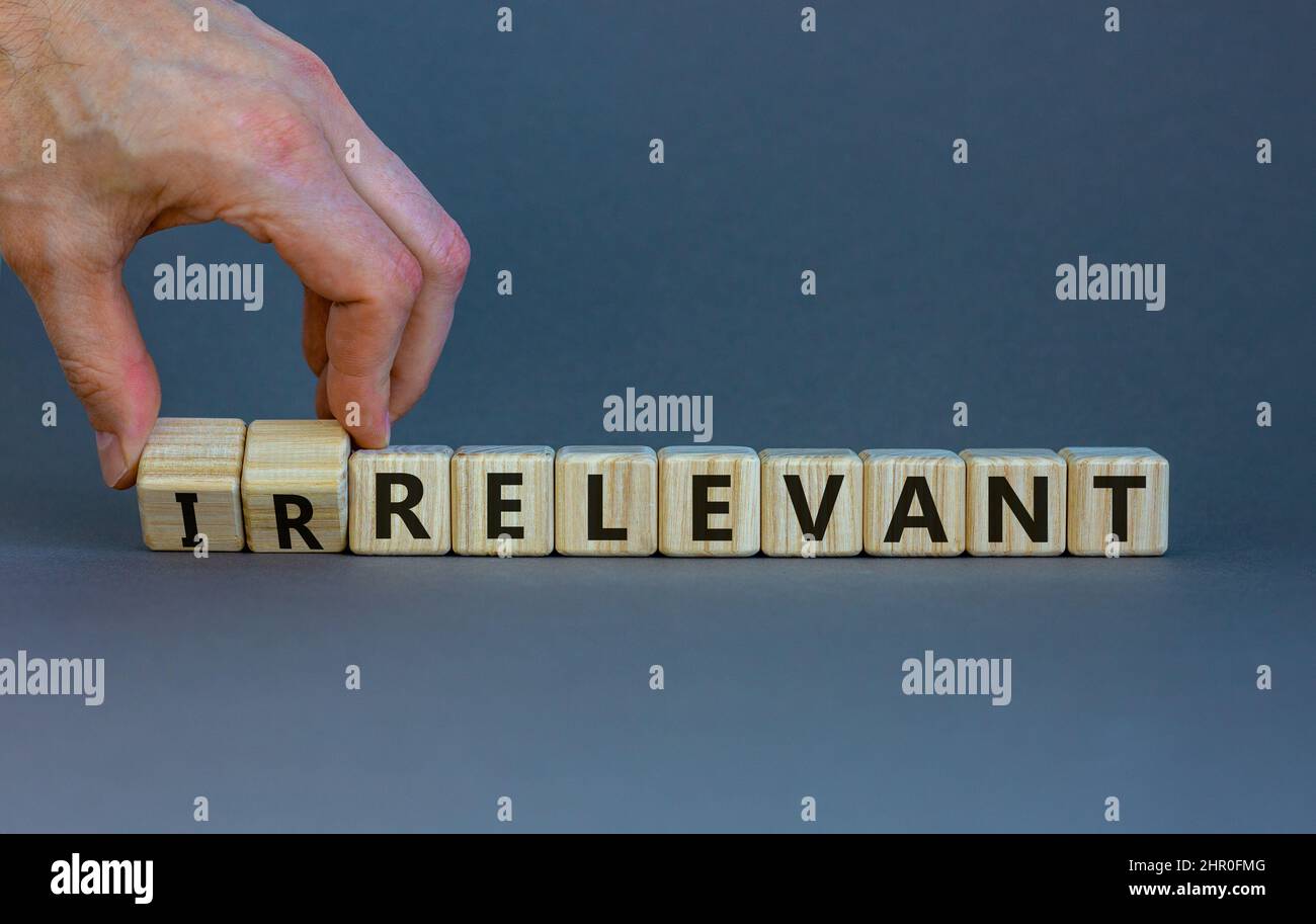 Relevant or irrelevant symbol. Businessman turns wooden cubes changes ...