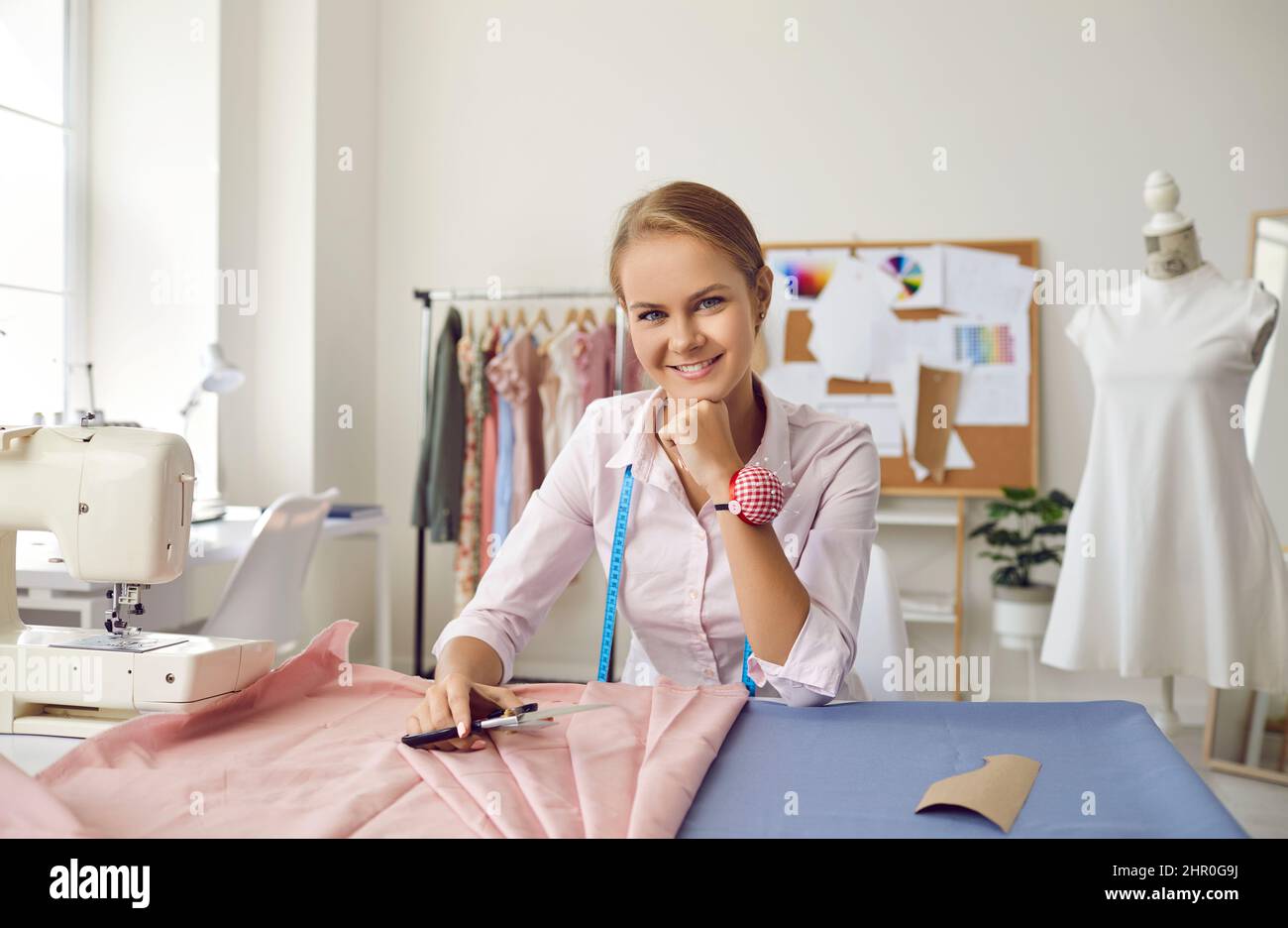 Smiling seamstress design new garment in fashion atelier Stock Photo ...