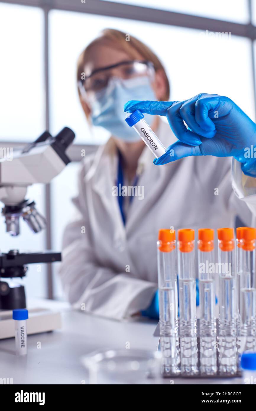 Female Lab Worker Wearing PPE Researching Covid-19 Omicron Variant In ...