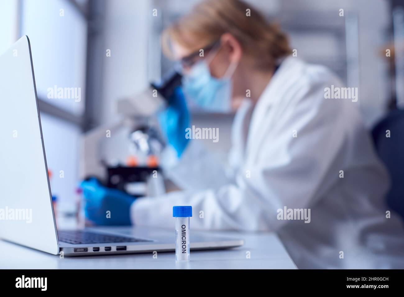 Female Lab Worker Wearing Lab Coat Working On Omicron Covid-19 Variant ...