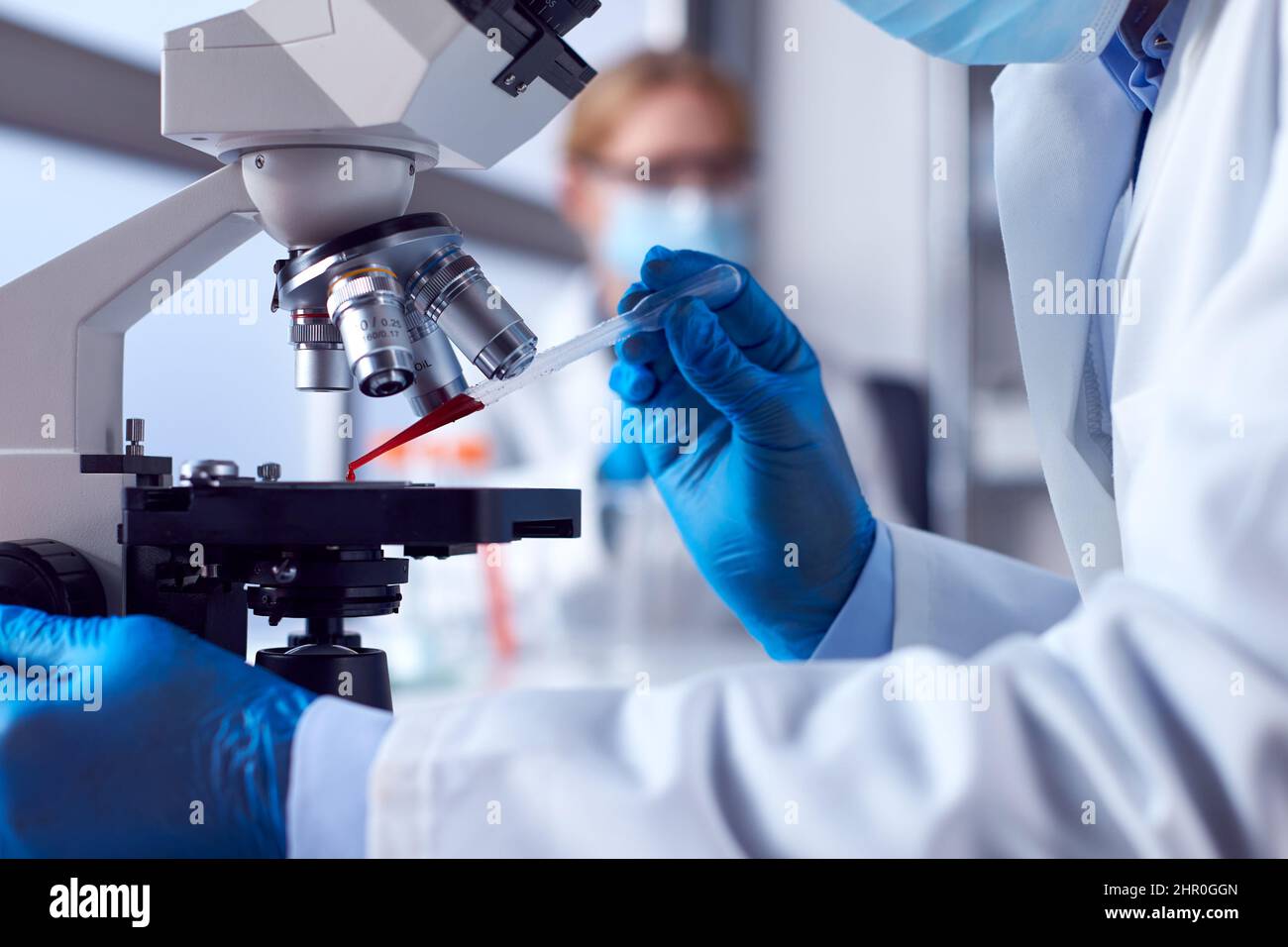 Two Female Lab Workers Wearing PPE Testing Blood Samples In Laboratory ...