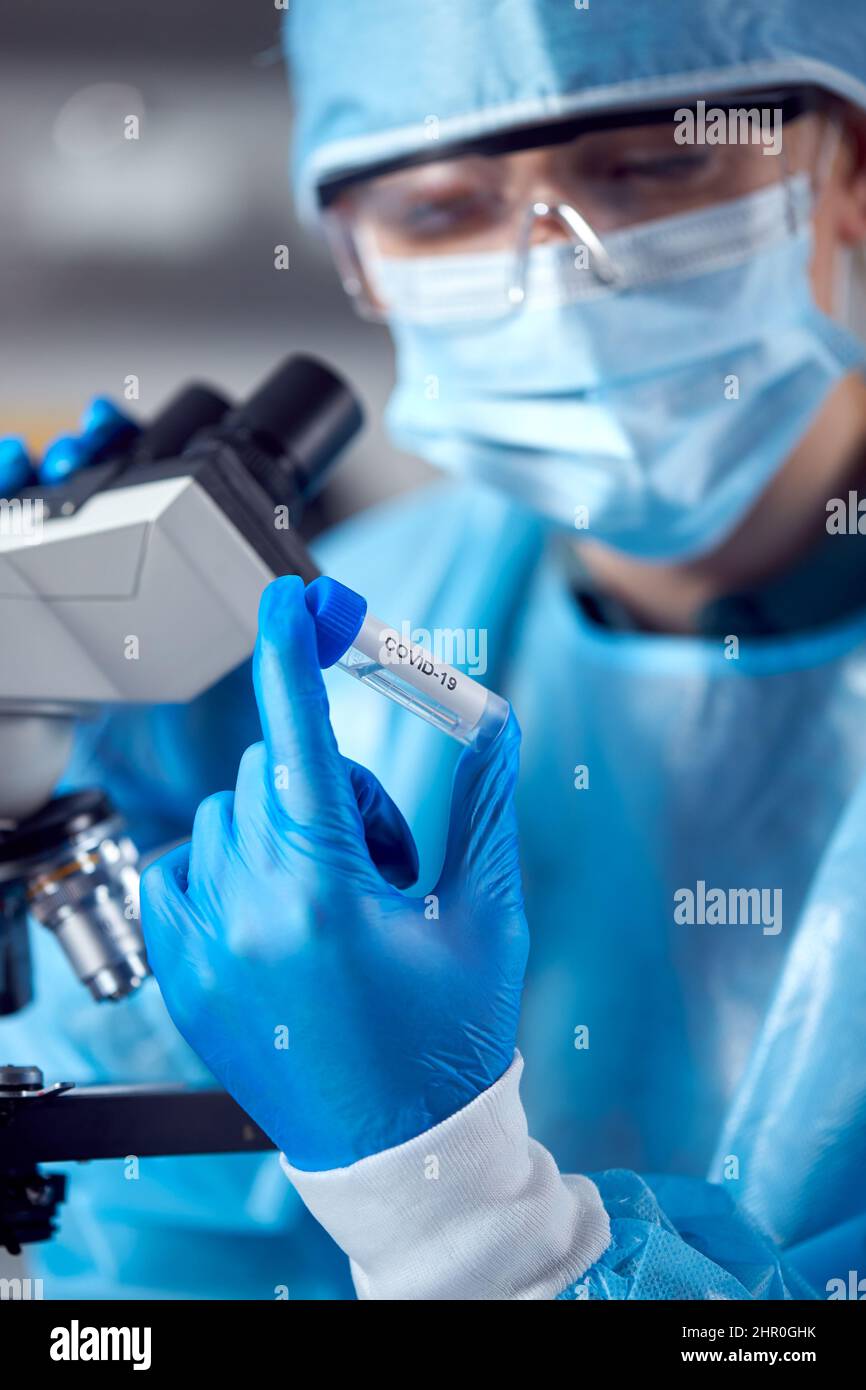 Close Up Of Female Lab Worker Wearing PPE Researching Covid-19 In ...