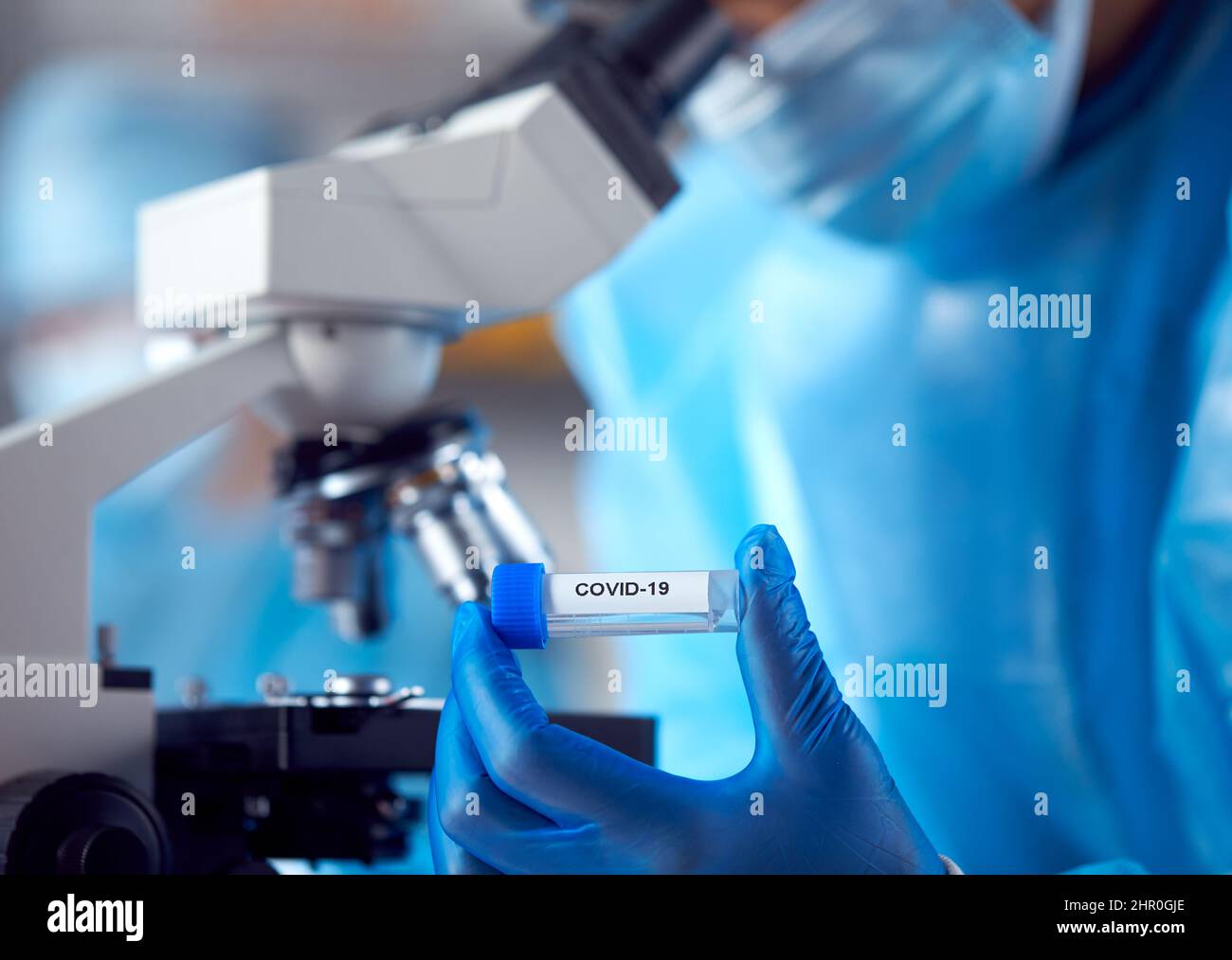 Close Up Of Female Lab Worker Wearing PPE Researching Covid-19 With ...
