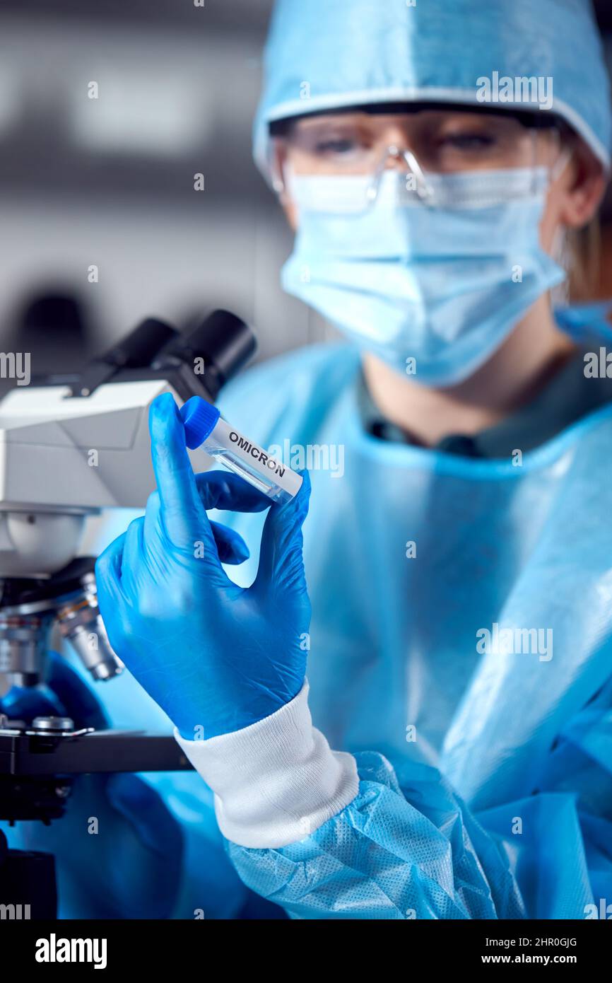 Close Up Of Female Lab Worker Wearing PPE Researching Omicron Variant ...
