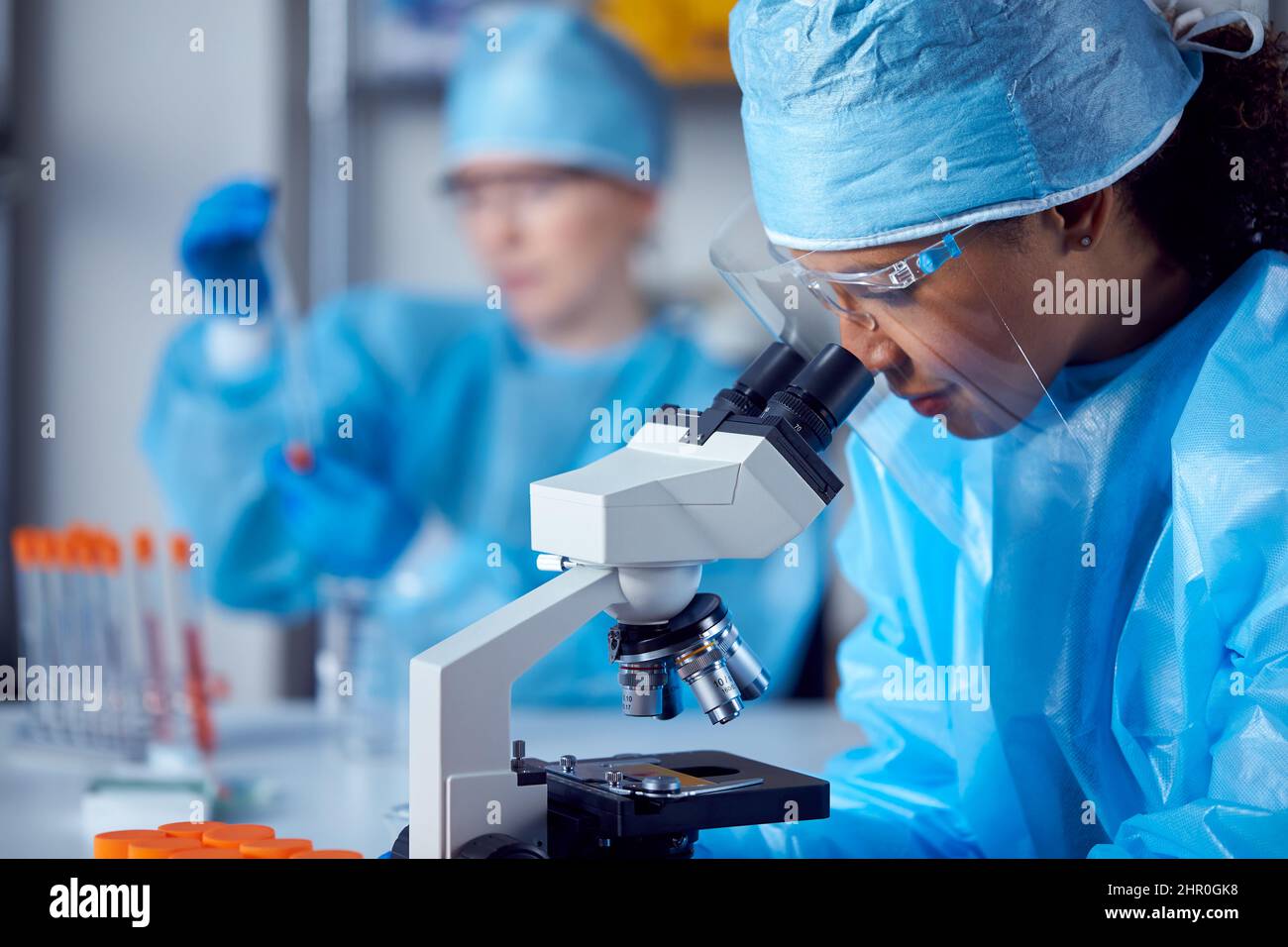 Female Lab Workers Wearing PPE Researching In Laboratory With ...